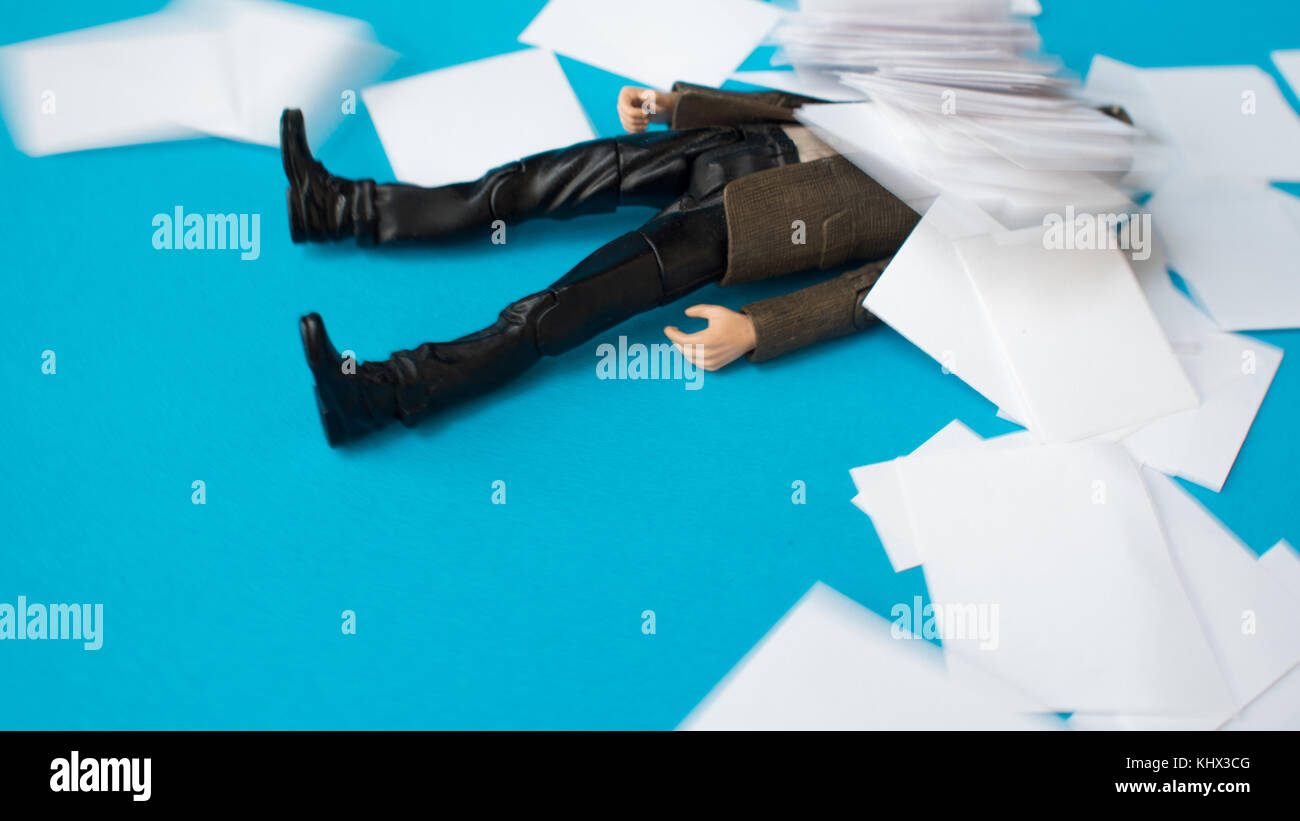 concept of a person swamped with paperwork, blue background Stock Photo ...