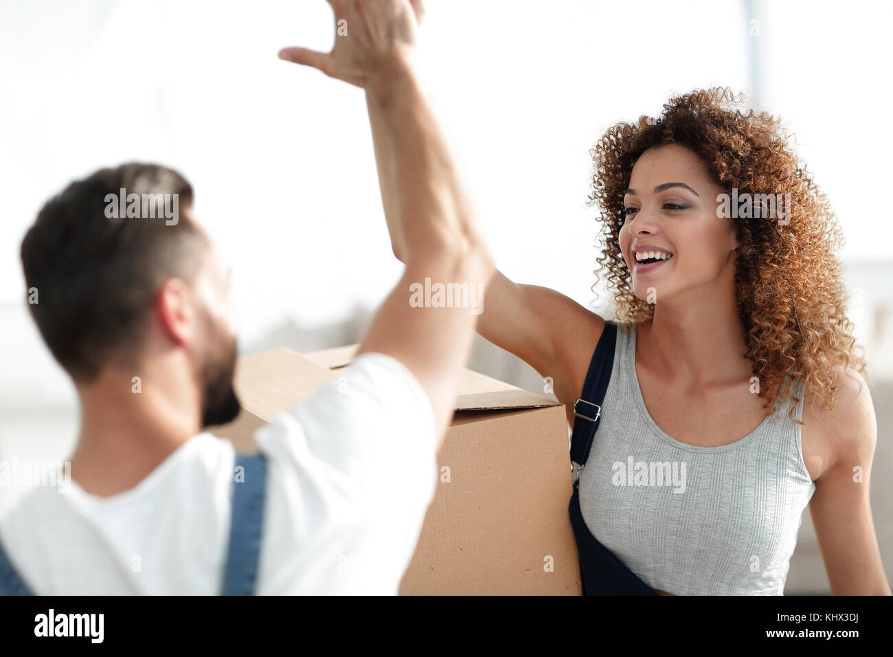 Happy and young couple giving a high five Stock Photo - Alamy