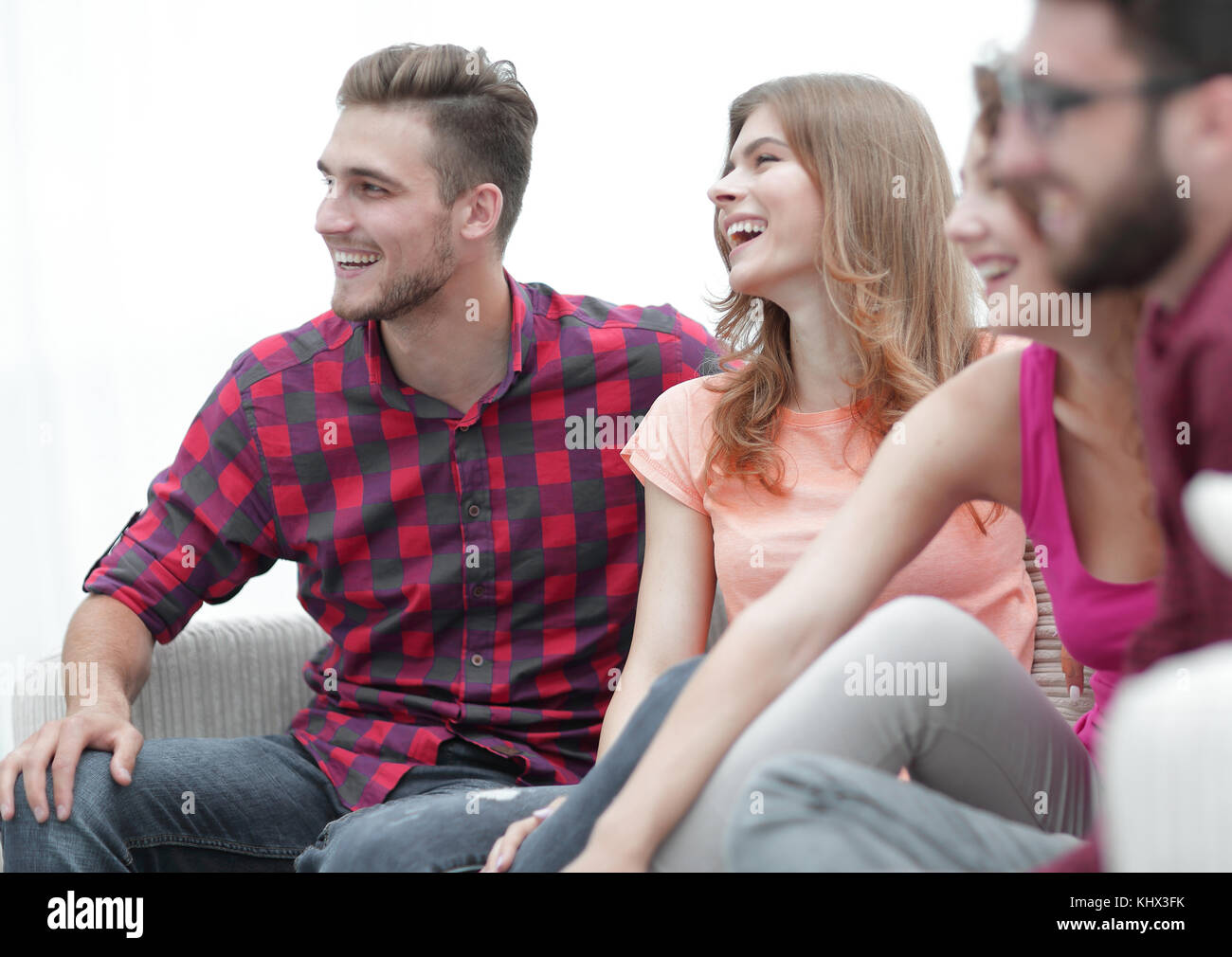 group of cheerful friends sitting on the couch Stock Photo - Alamy