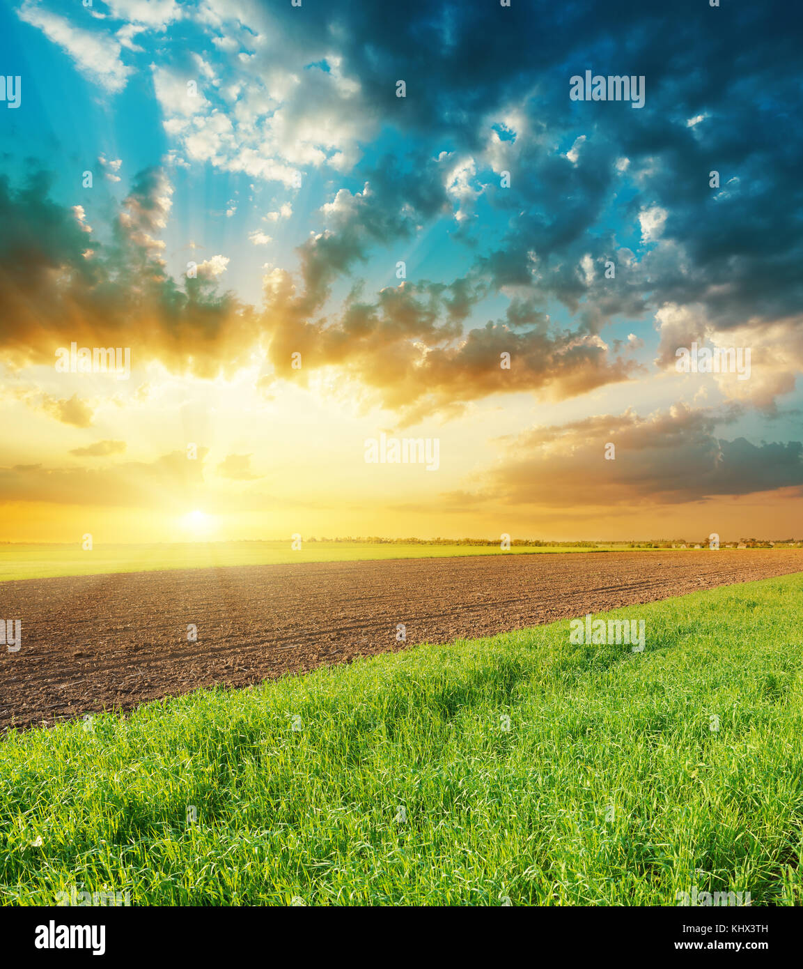 orange sunset over agriculture fields Stock Photo - Alamy