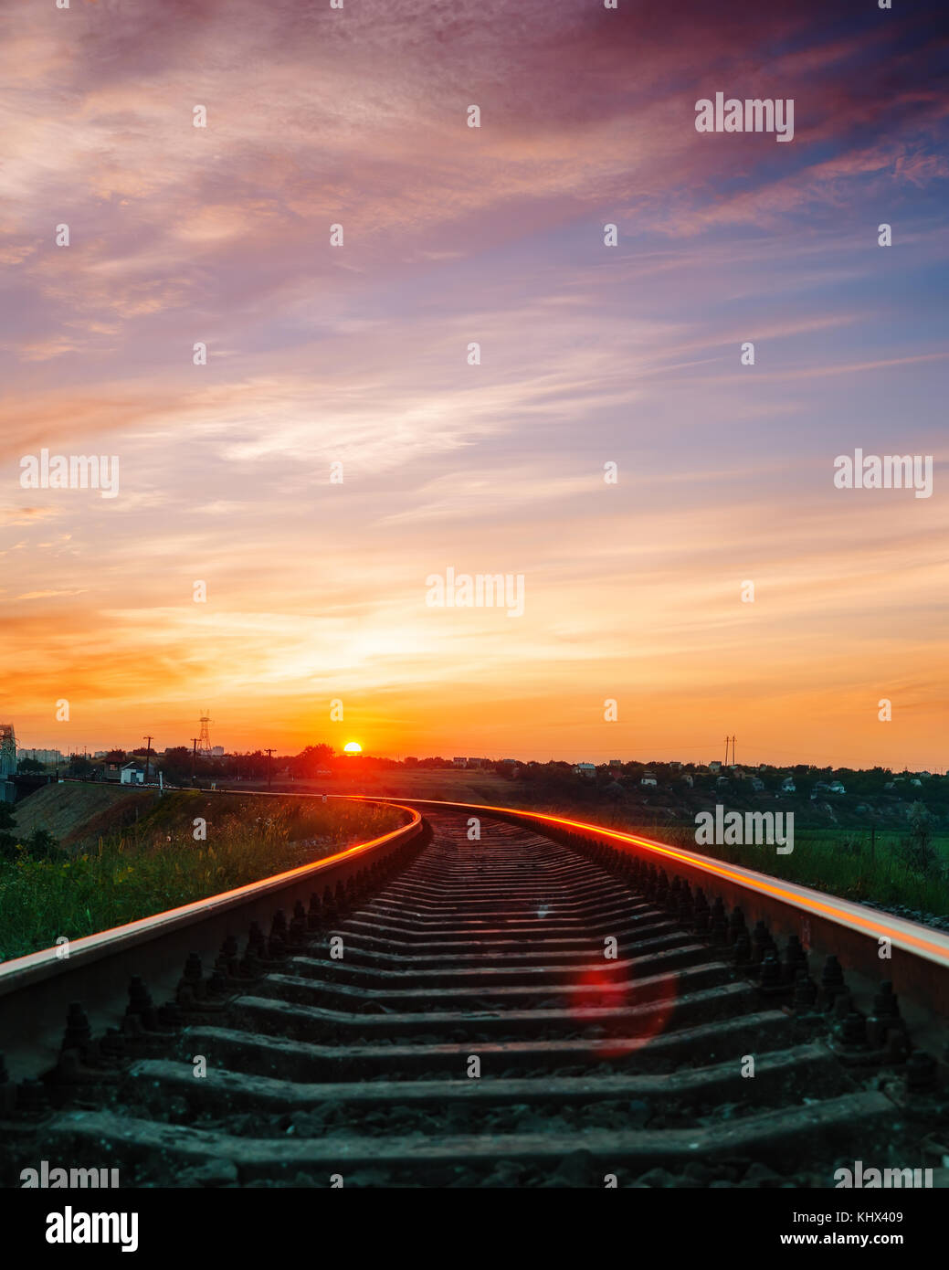 sunset over railroad in violet sky with clouds Stock Photo - Alamy