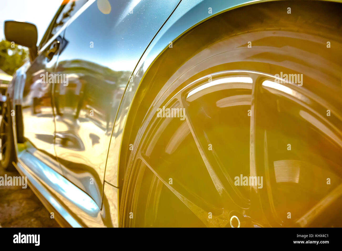 Car rim and side close up with a natural, in-camera lens flare. Various ...