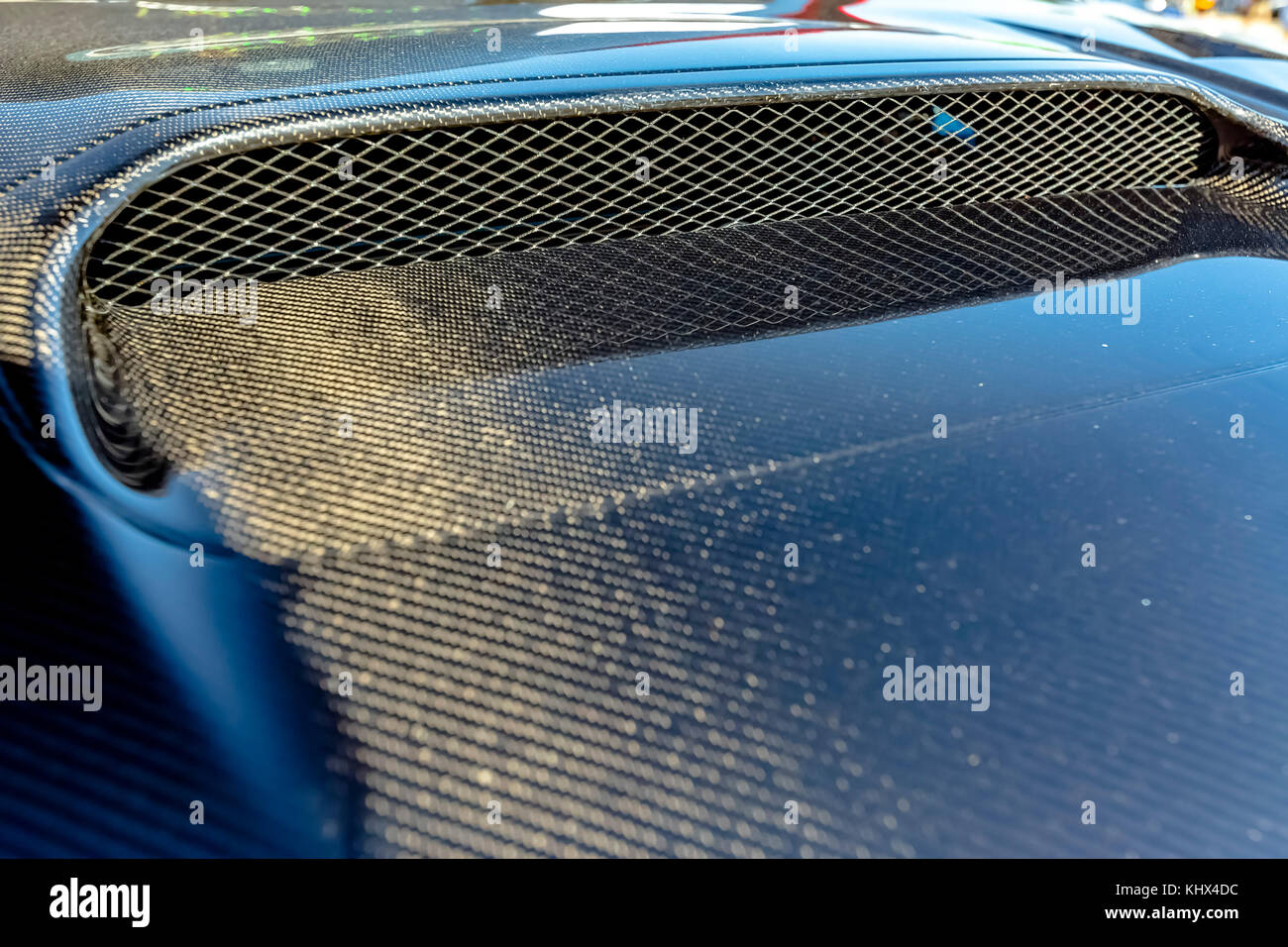 Carbon fiber texture on the hood of a car with vent. Various vehicle ...