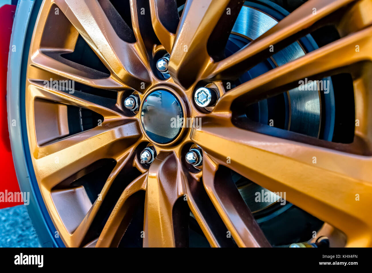 Close up of a car's orange rim, wheel with no emblem. Custom cars in ...