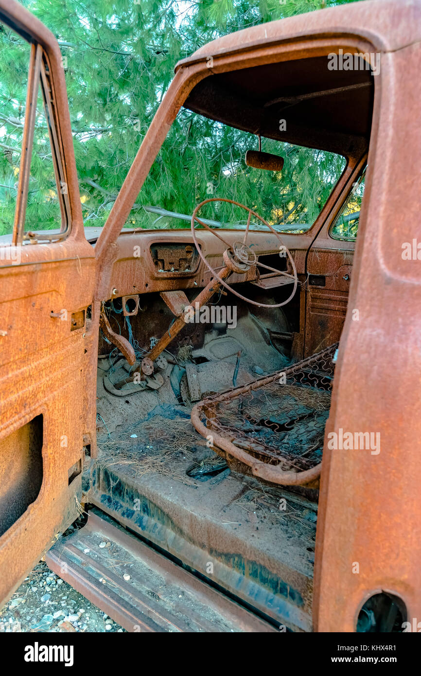 Forest Relic Old Car rusting away in the Forest with open door. Broken ...