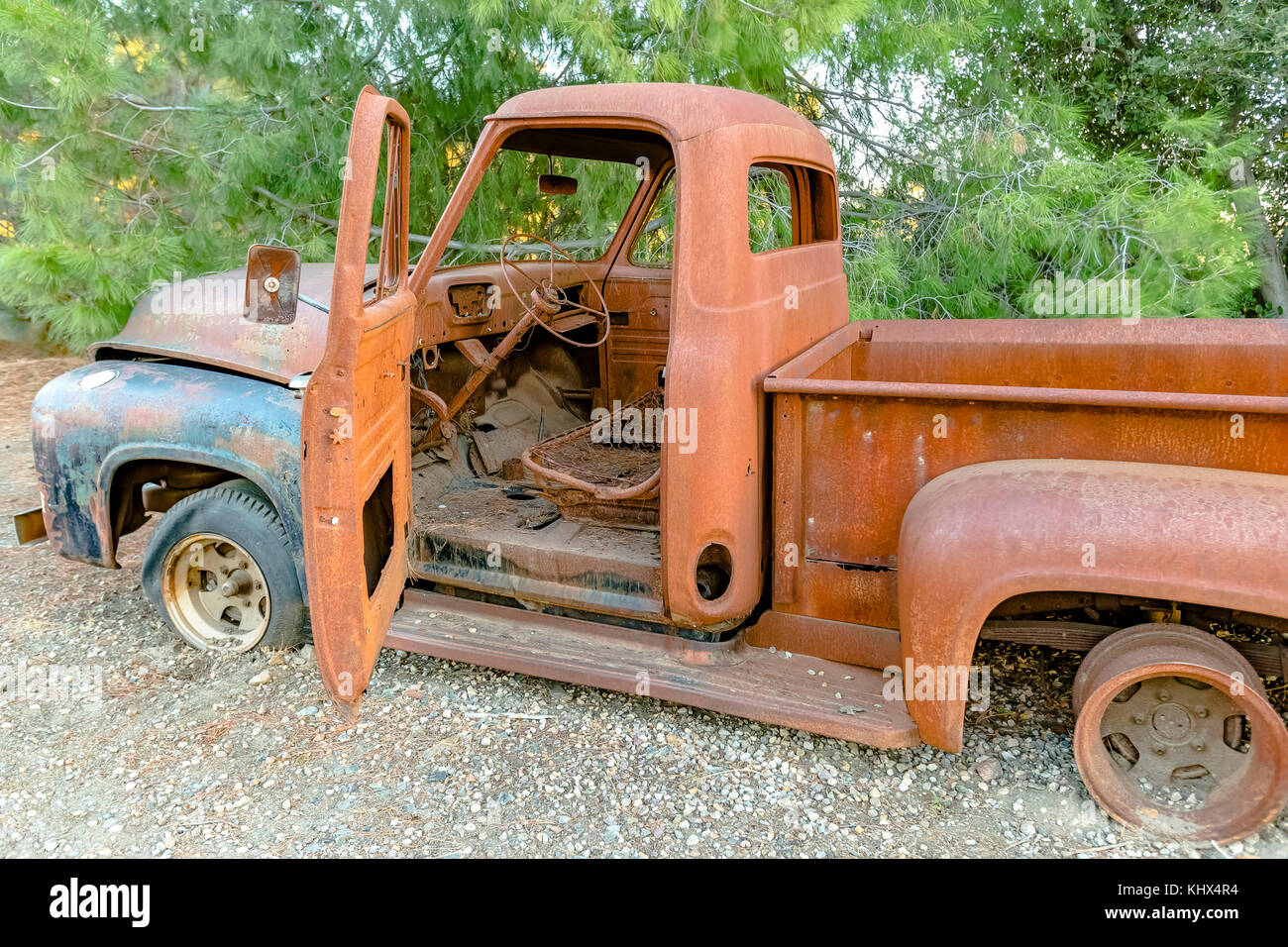 Forest Relic Old Car rusting away in the Forest with missing tire ...