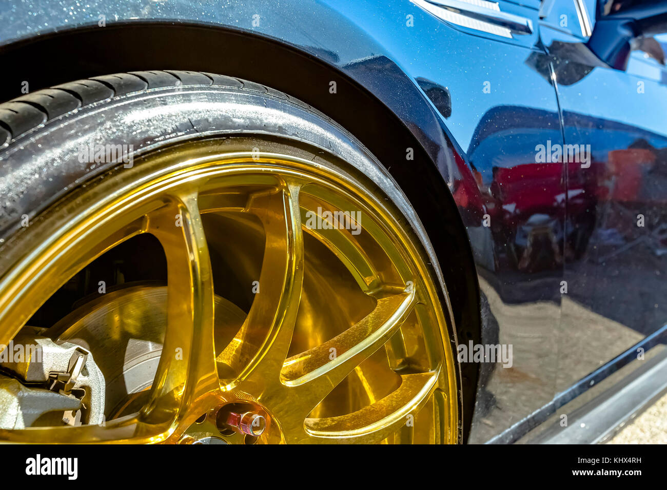 Golden car rims on a black car at an event in Orange County Calfornia ...