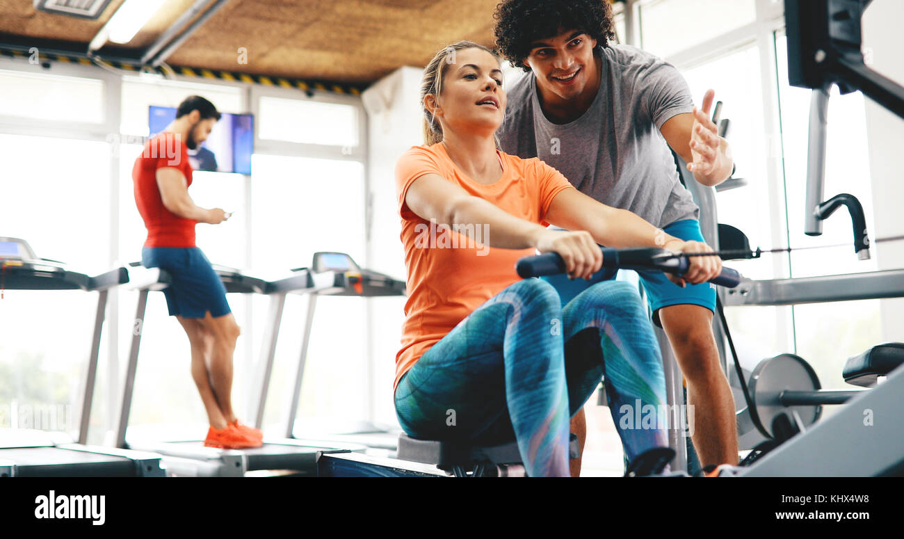 Personal trainer helping woman reach goals Stock Photo - Alamy