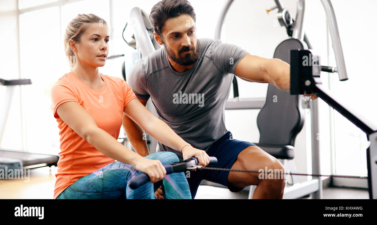 Personal trainer giving instructions in gym Stock Photo - Alamy