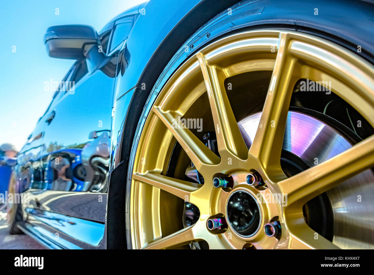 Golden rims with reflective black car and break pads showing through ...