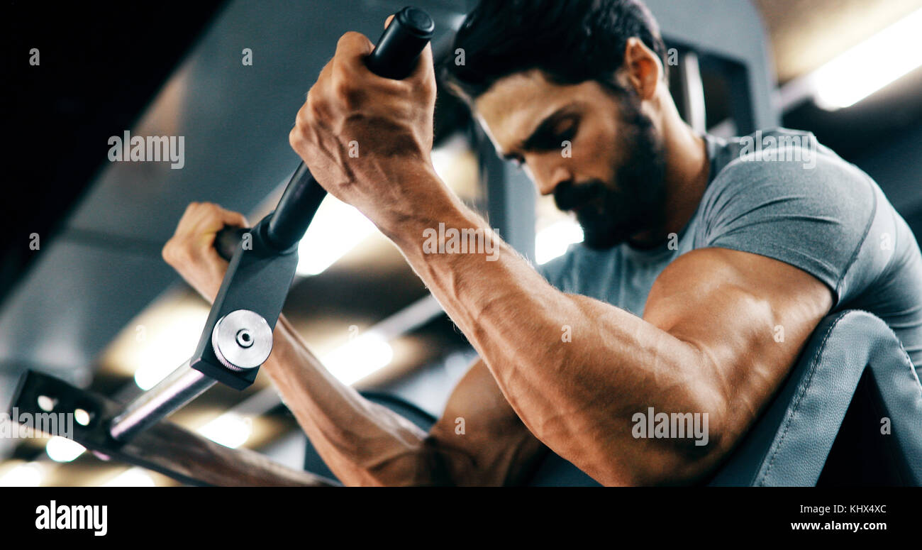 Young handsome man doing exercises in gym Stock Photo - Alamy