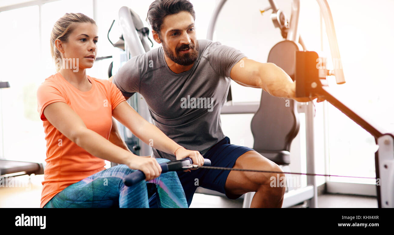 Personal trainer helping Stock Photo - Alamy