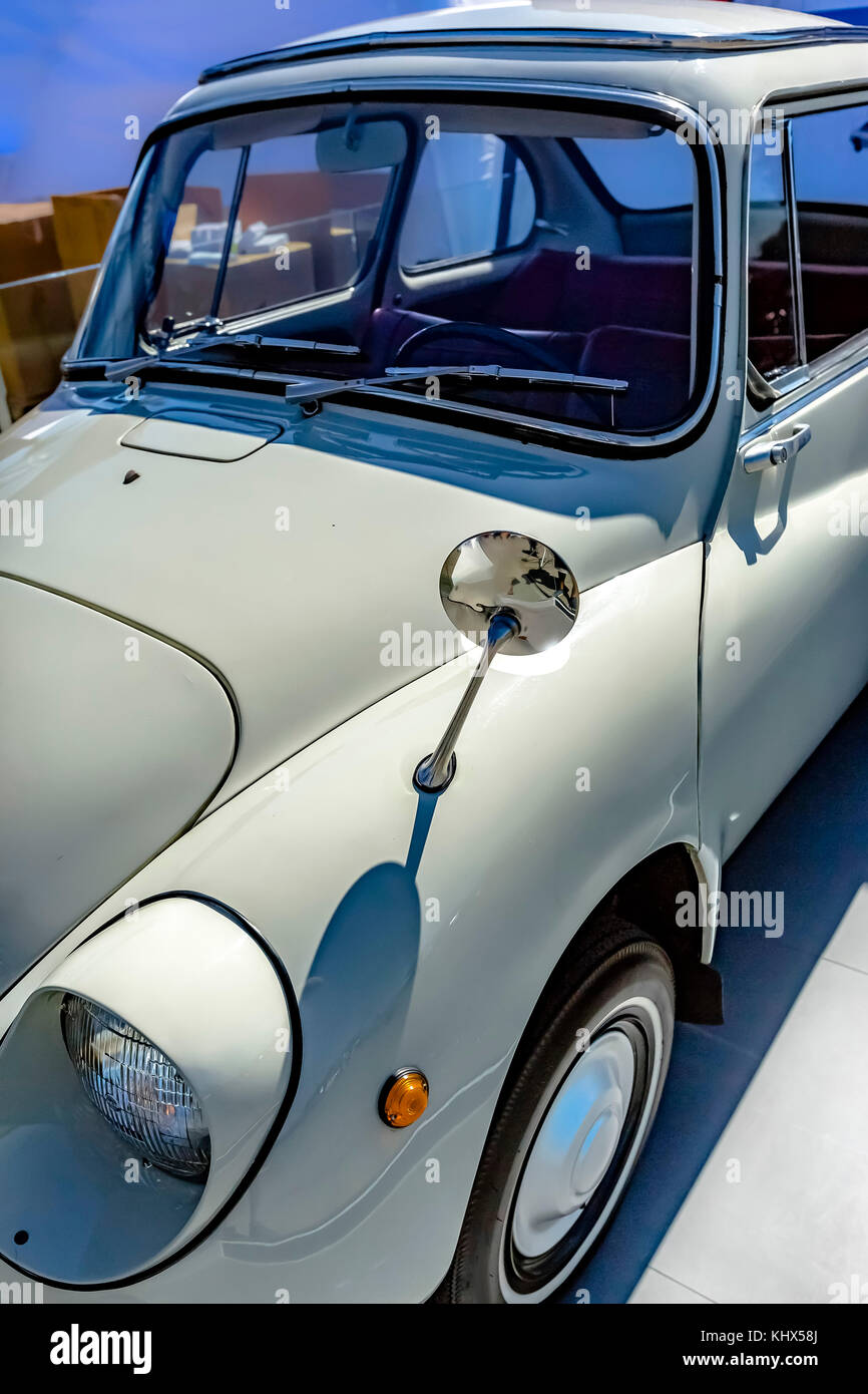 Old style compact car with vintage features from the driver's side ...