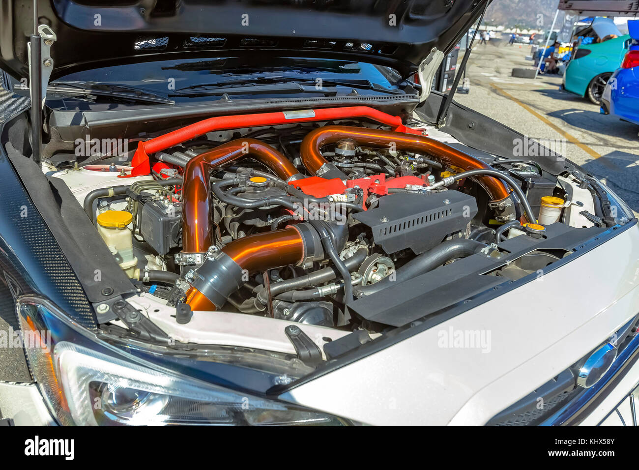Open hood with red pipes in a white car. Custom cars in Southern ...