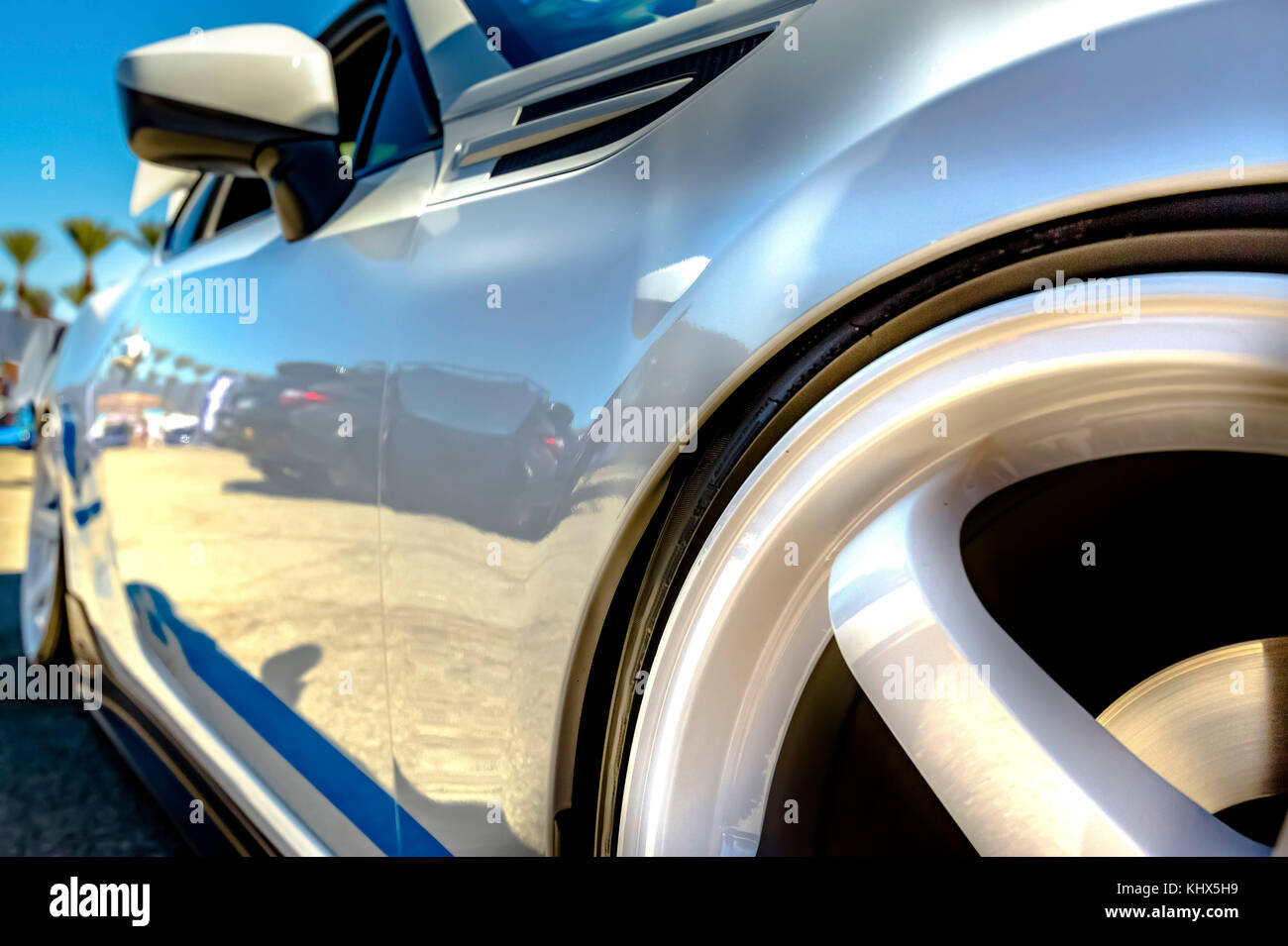 White car with blue strips and white rims closeup shot from the front ...