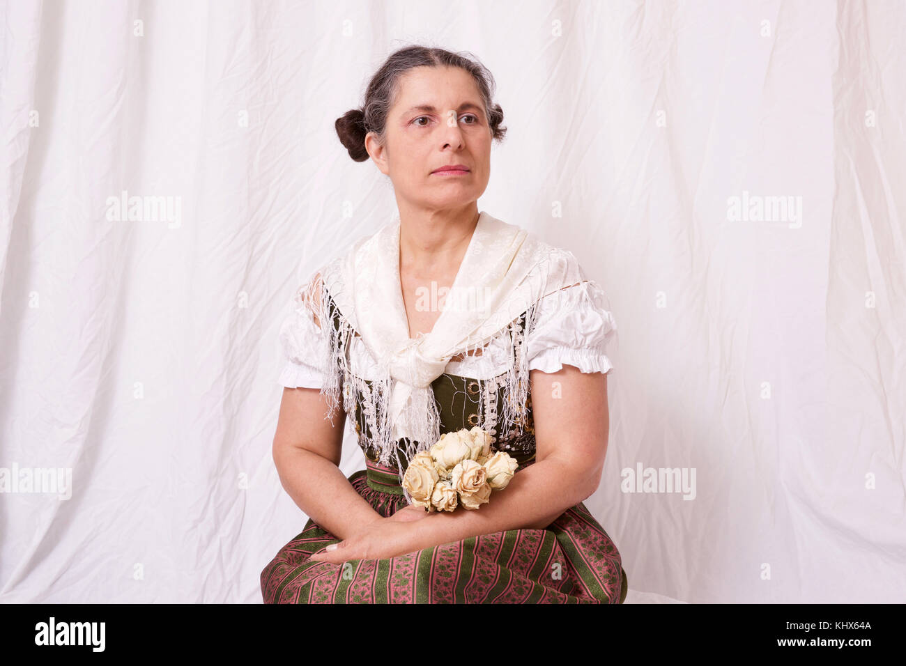 Portrait of a german woman with traditonal costume at studio with white ...