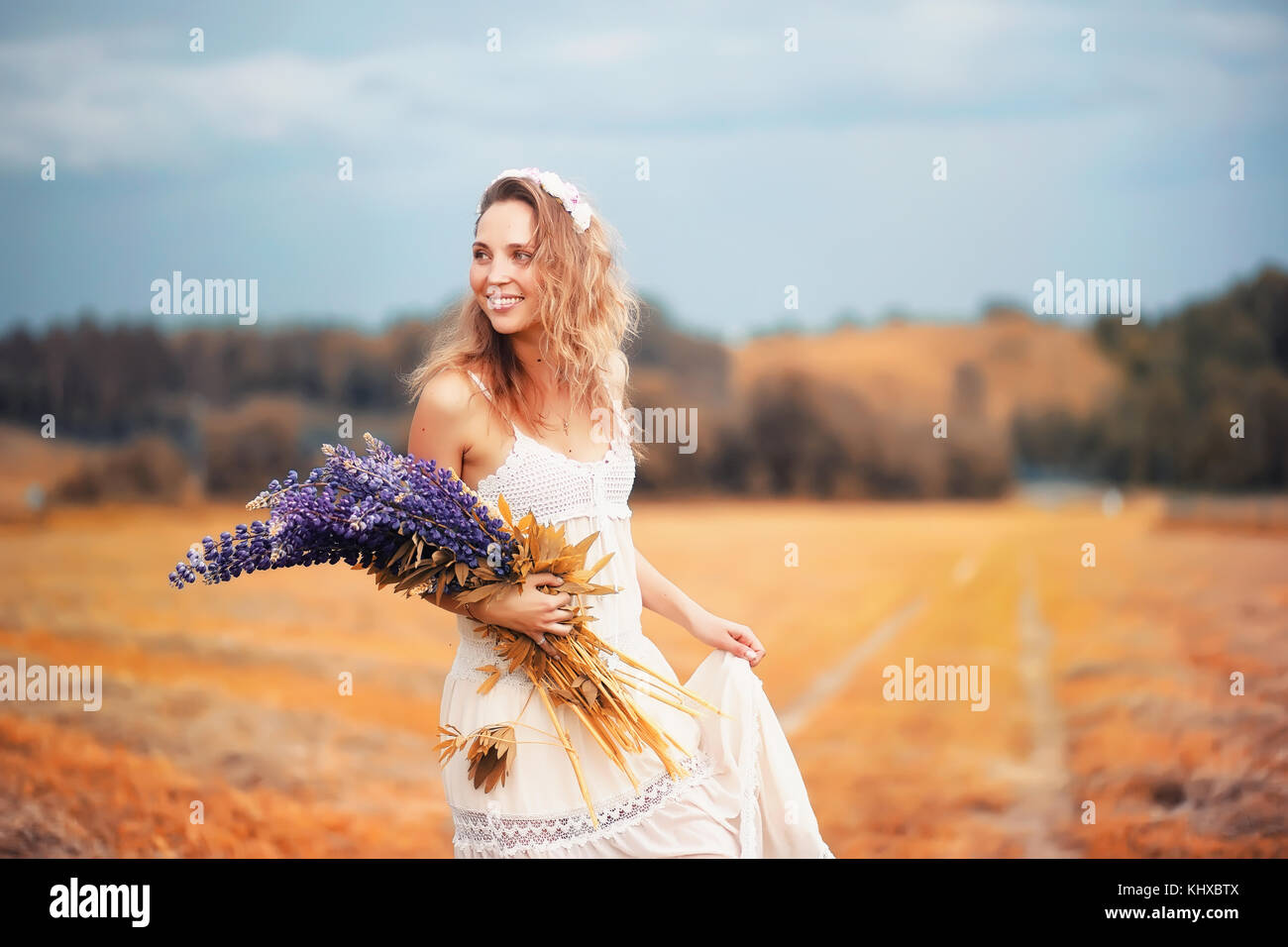 Girl with a bouquet of flowers in autumn Stock Photo - Alamy
