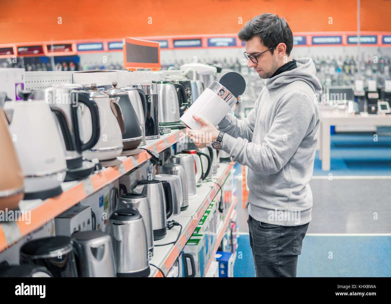 customer chooses a kettle in supermarket mall Stock Photo - Alamy
