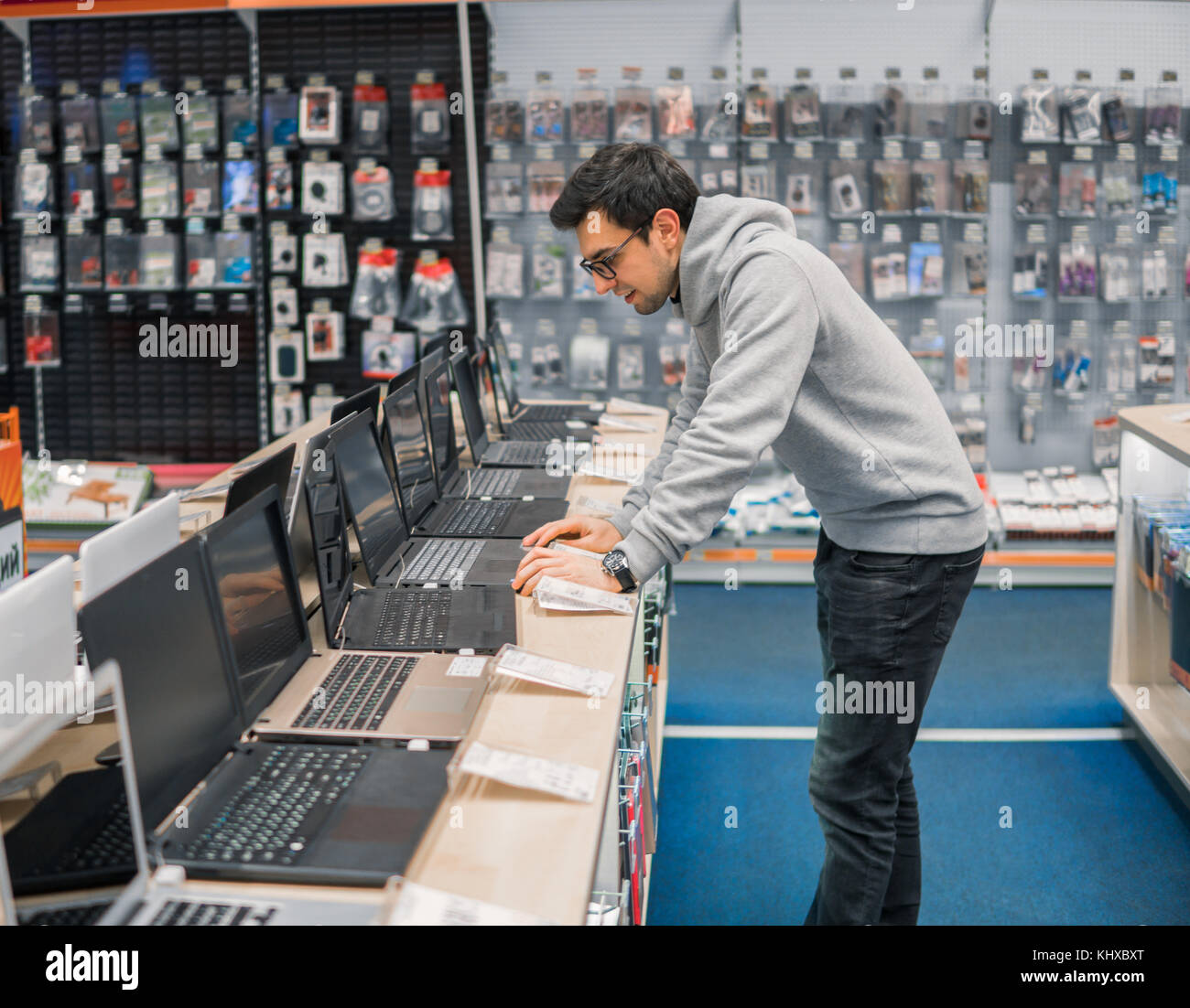 modern male customer choosing laptop in the computer shop Stock Photo ...