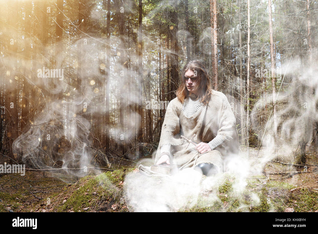 A man in a cassock spends a ritual in a dark forest Stock Photo - Alamy