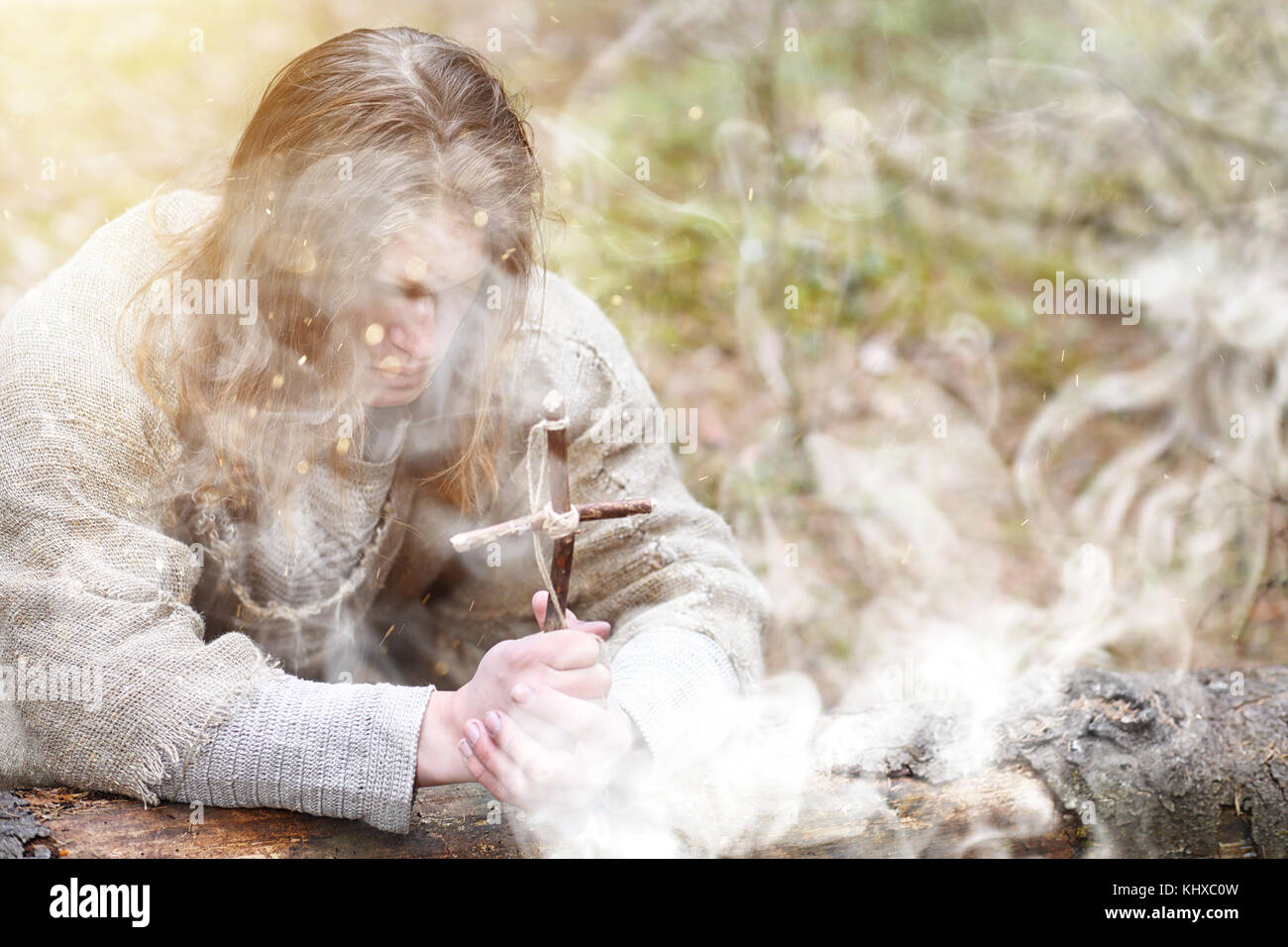 A man in a cassock spends a ritual in a dark forest Stock Photo - Alamy