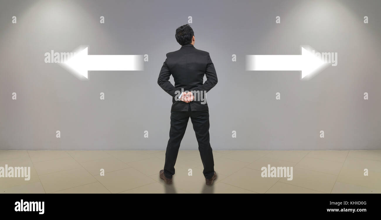 Businessman standing in doubt,thinking the two different choices ... Businessman standing in doubt,thinking the two different choices ...