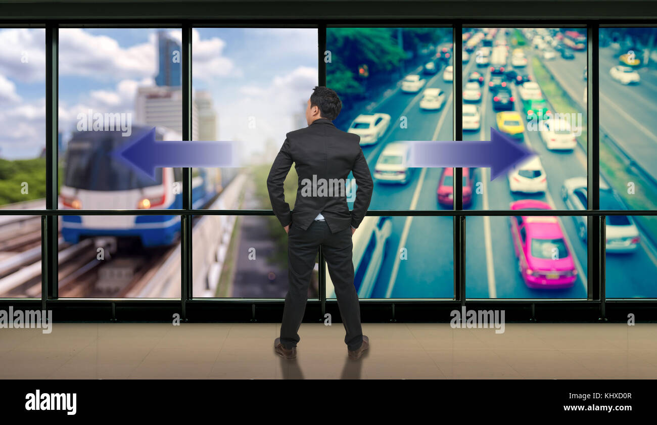 Businessman standing in doubt,thinking the two different choices of ... Businessman standing in doubt,thinking the two different choices of ...
