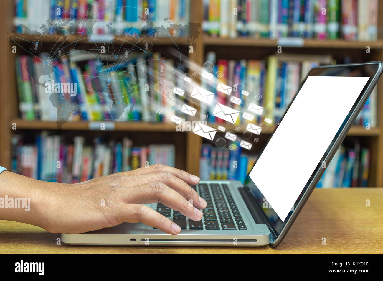 Hand typing on laptop computer with email and network line over the ...