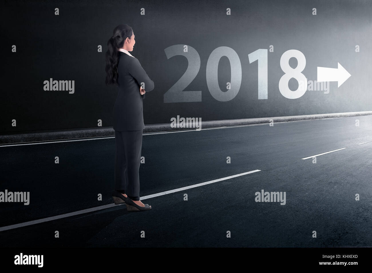 Back view asian business woman standing with a 2018 sign out of the ...