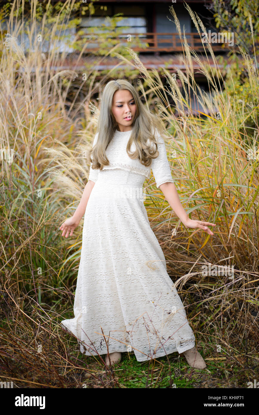 Beautiful japanese model posing in autumn field with hay Stock Photo ...