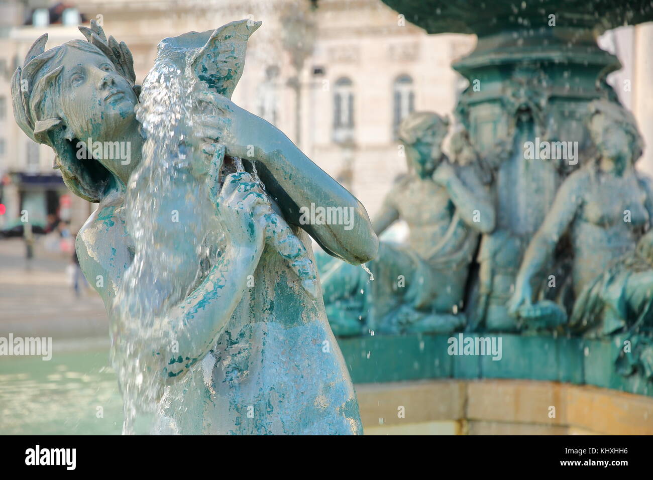Fountains in Rossio Square, close-up on one of the mermaid statues in ...