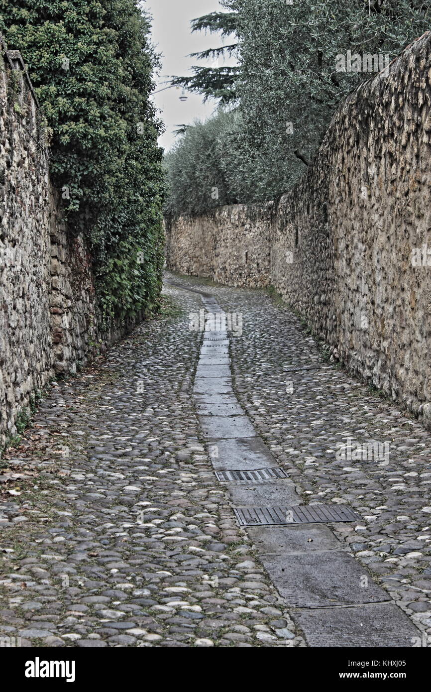 Pathway or walkway next to an old wall Stock Photo - Alamy