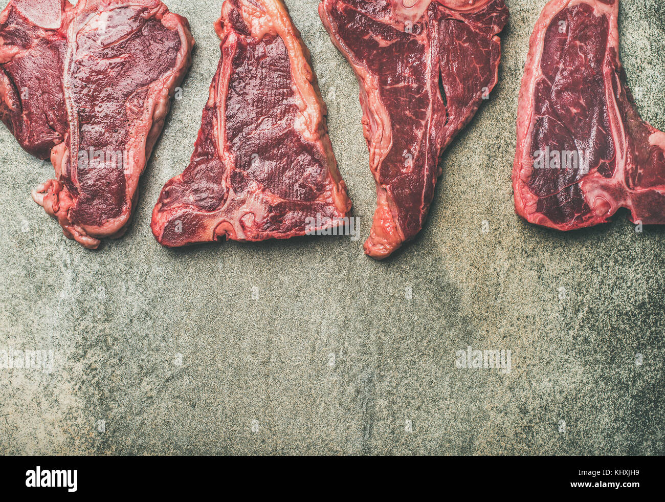 Flat-lay of fresh raw beef meat steaks over concrete background Stock ...