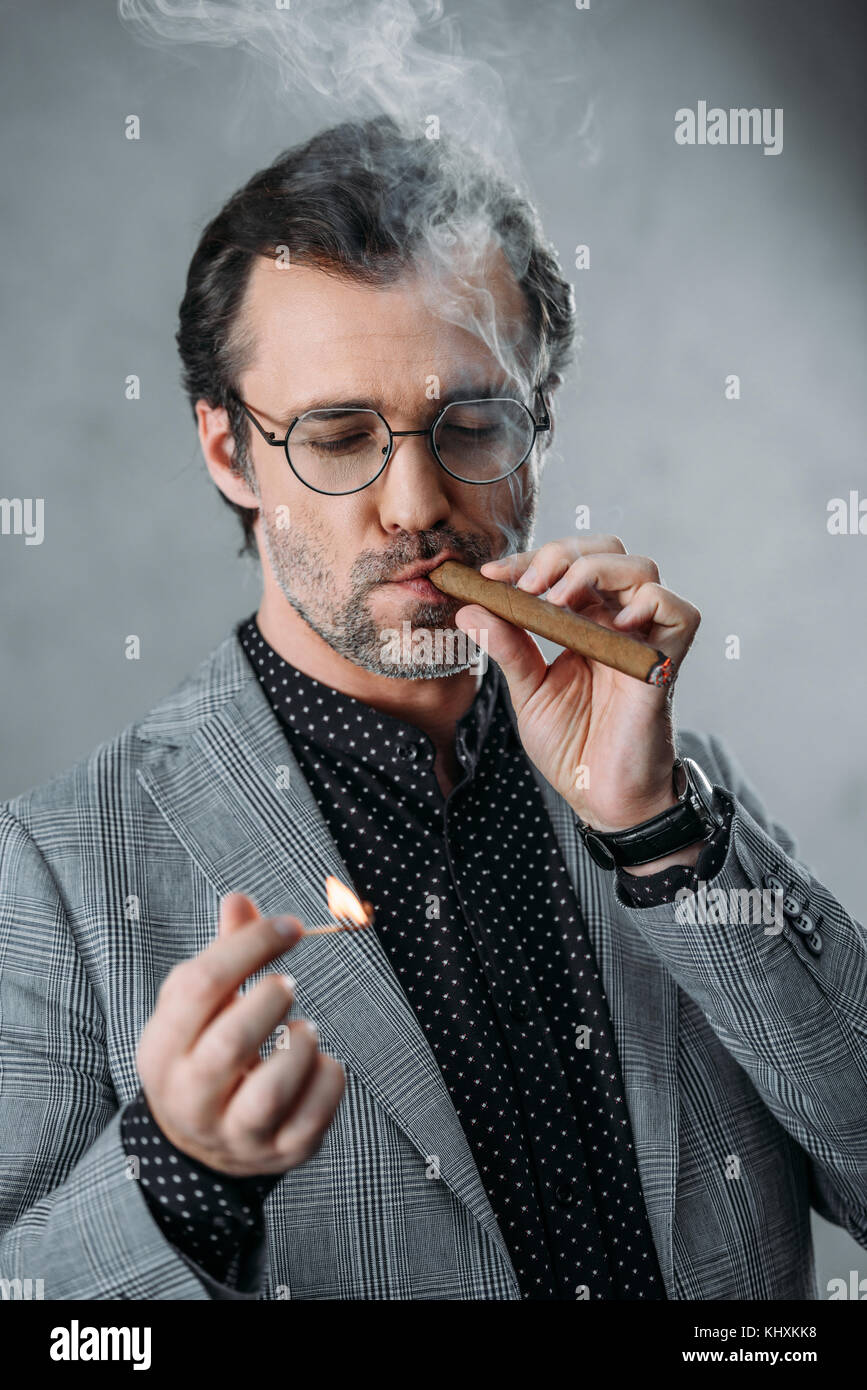 businessman smoking cigar Stock Photo - Alamy