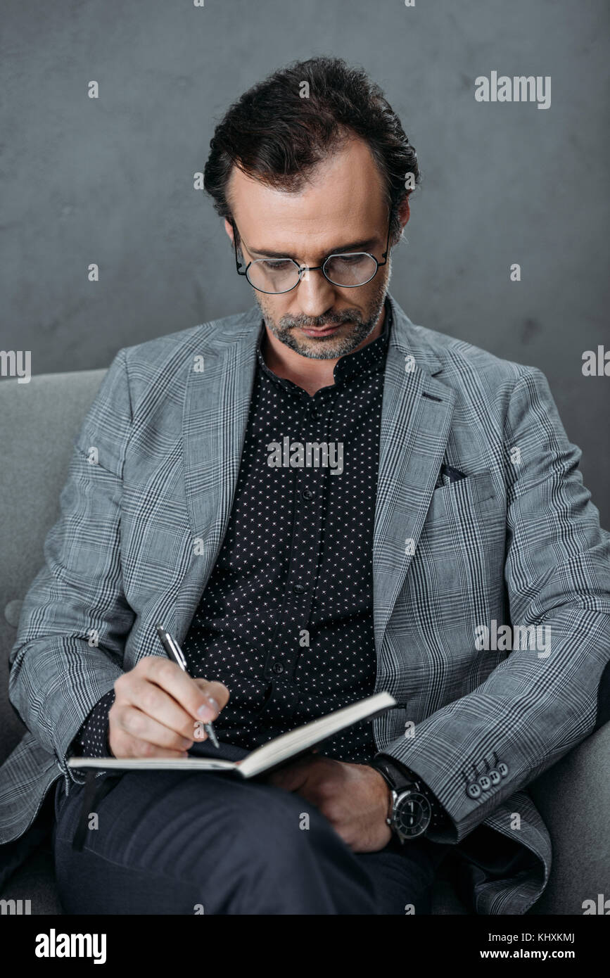businessman taking notes in notebook Stock Photo - Alamy