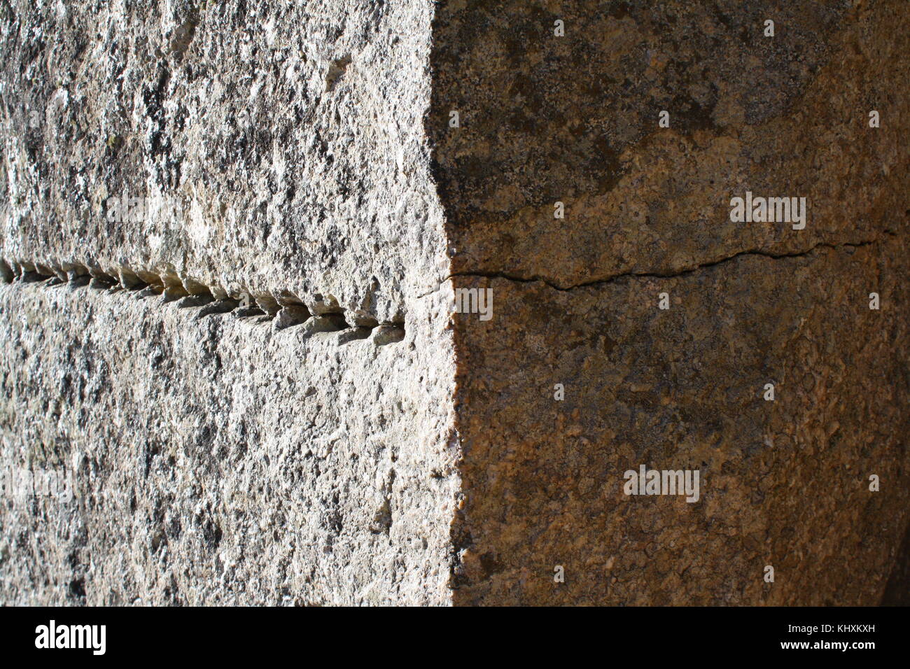Dividing a rock into two parts, with drilled holes Stock Photo - Alamy