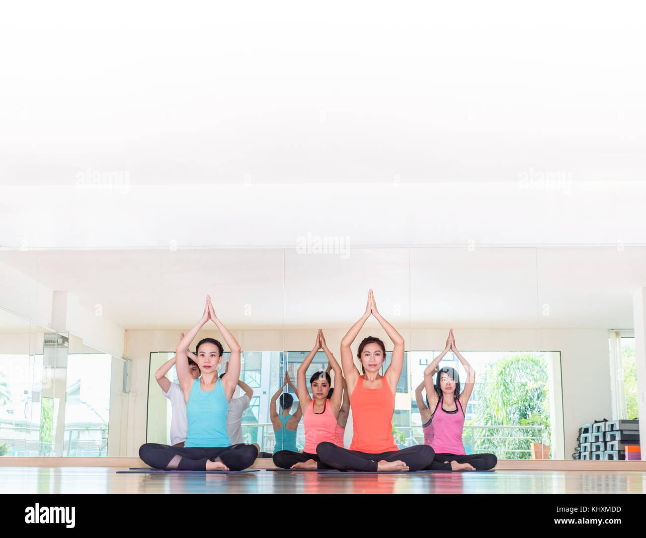Yoga class in studio room,Group of people doing seated tree pose with ...