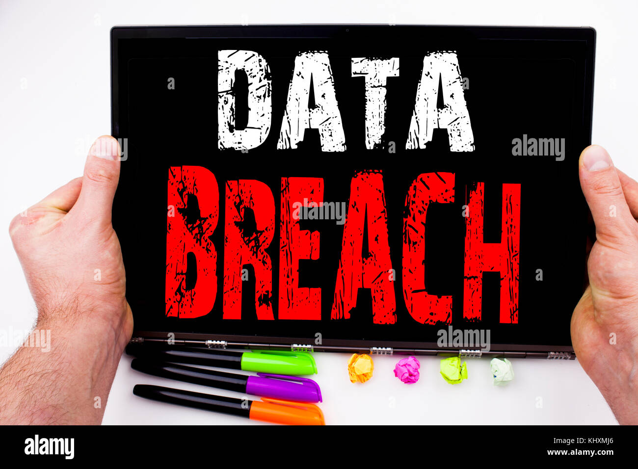 Writing showing Data Breach made in the office with surroundings laptop ...