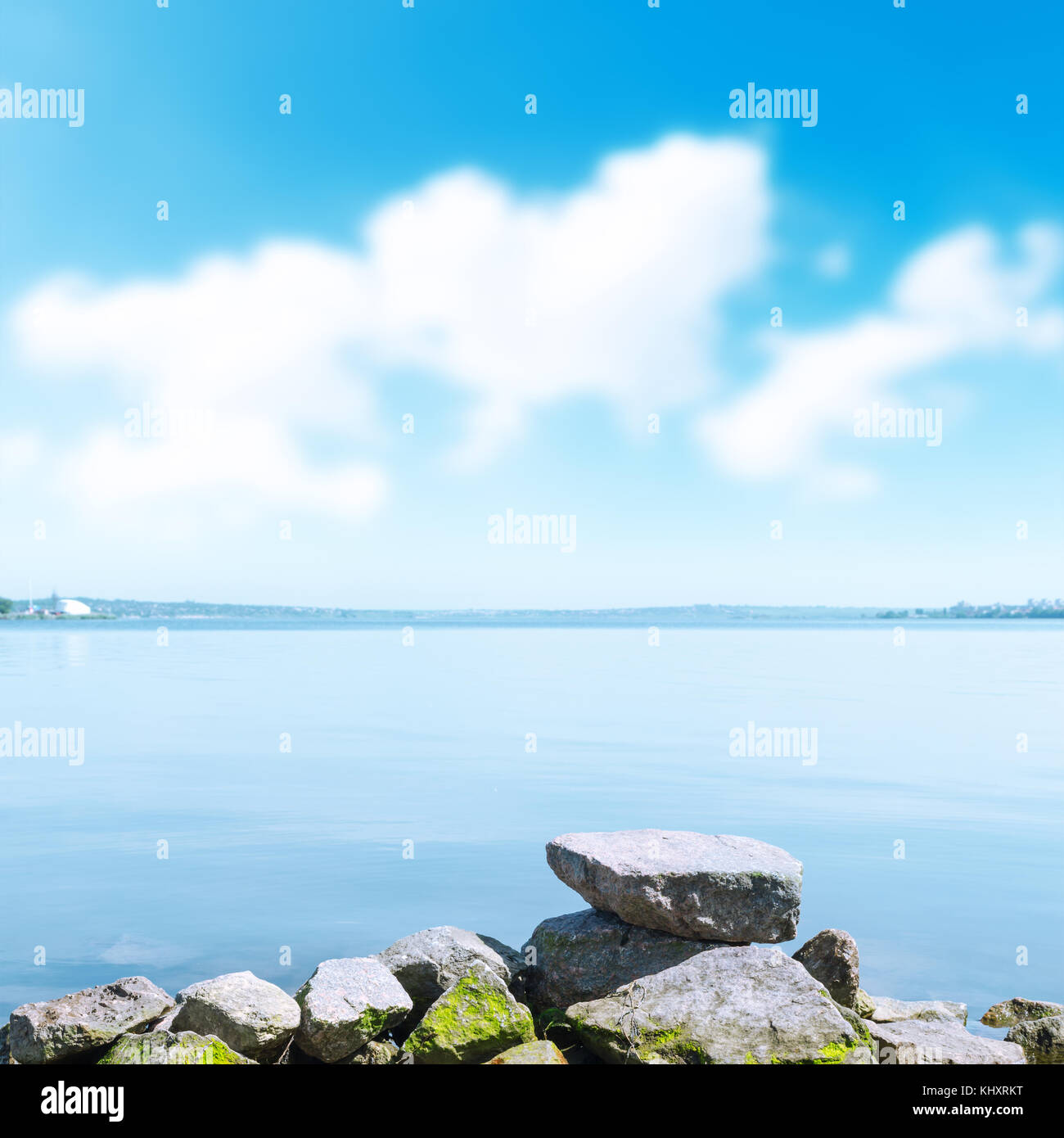 stones near river under blue sky with clouds. soft focus Stock Photo ...