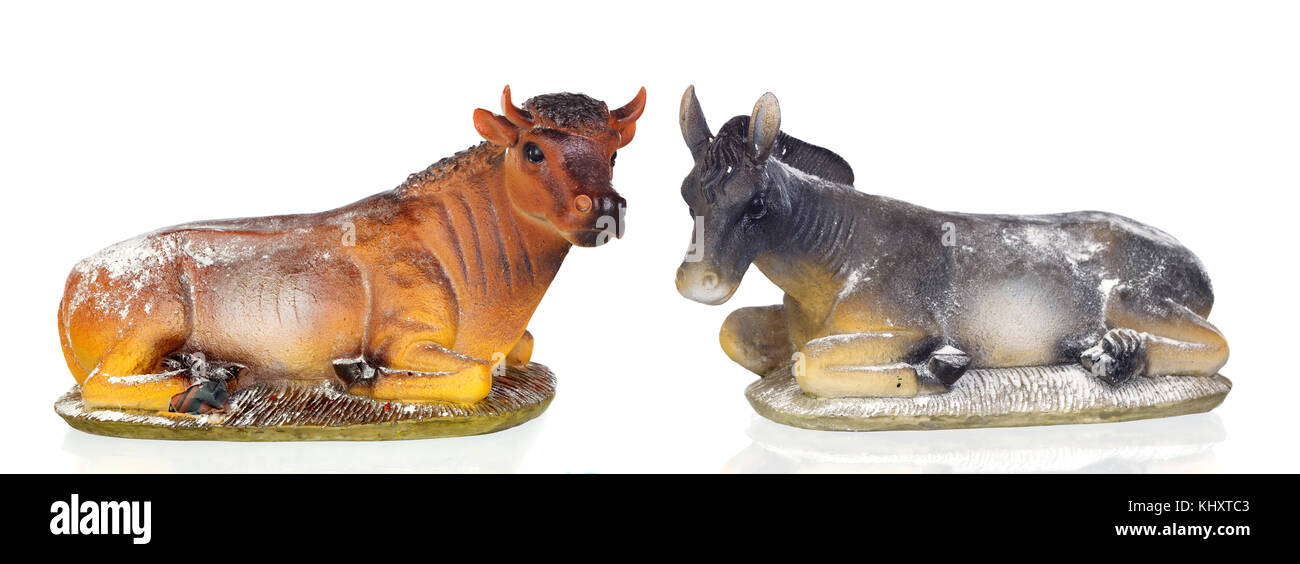 Figures of a ox and a mule for the Nativity Potal isolated on a white ...