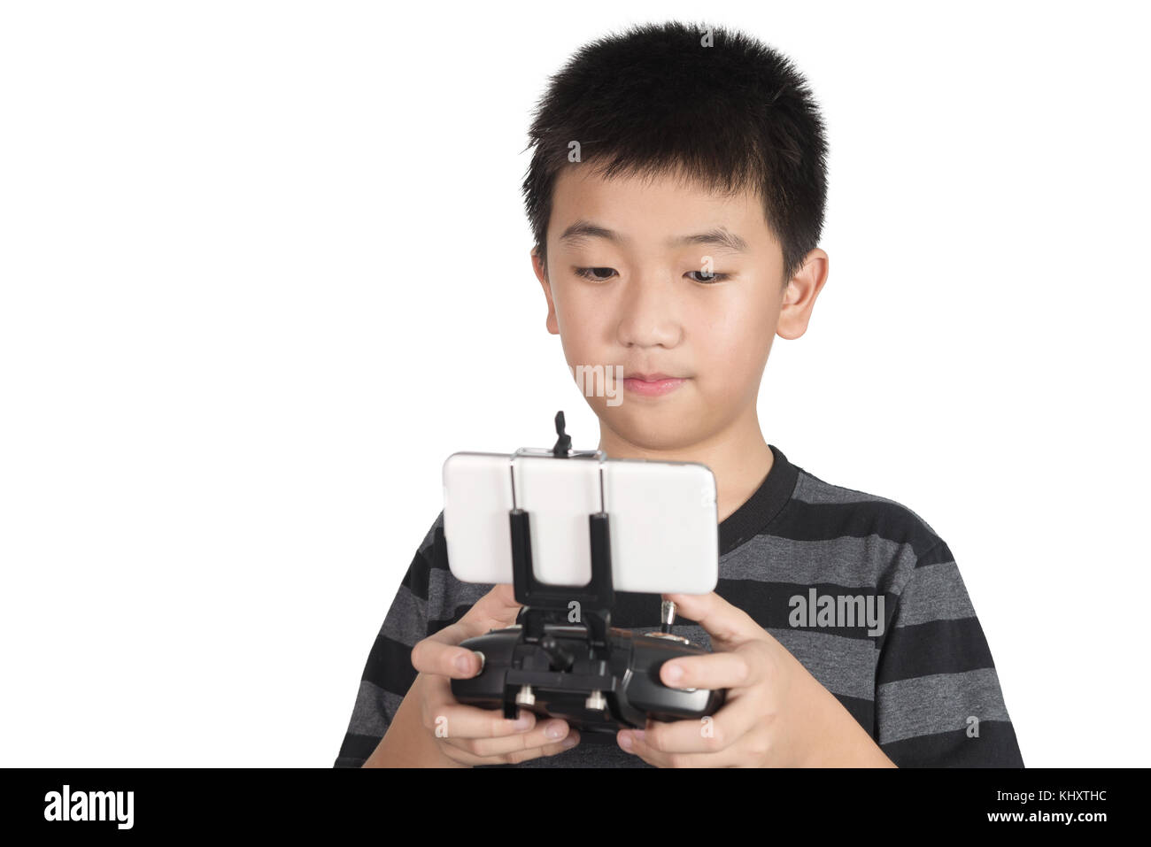 Asian boy holding radio remote control (controlling handset) for ...