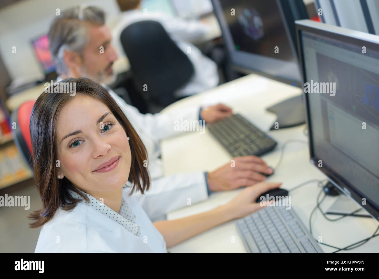 Portrait of woman at computer station Stock Photo - Alamy