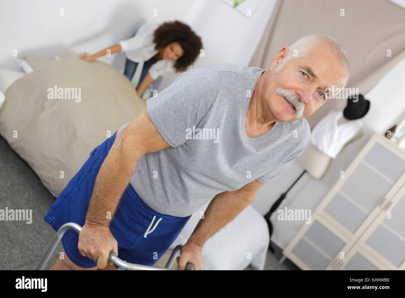 senior male patient using walker at rehab center Stock Photo - Alamy