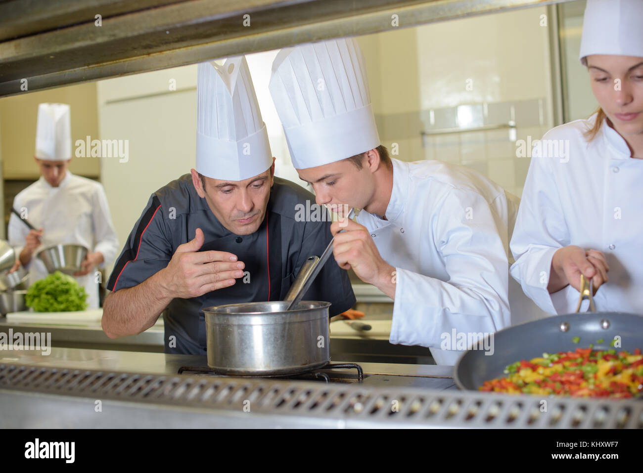 Chef smelling aroma from saucepan Stock Photo - Alamy