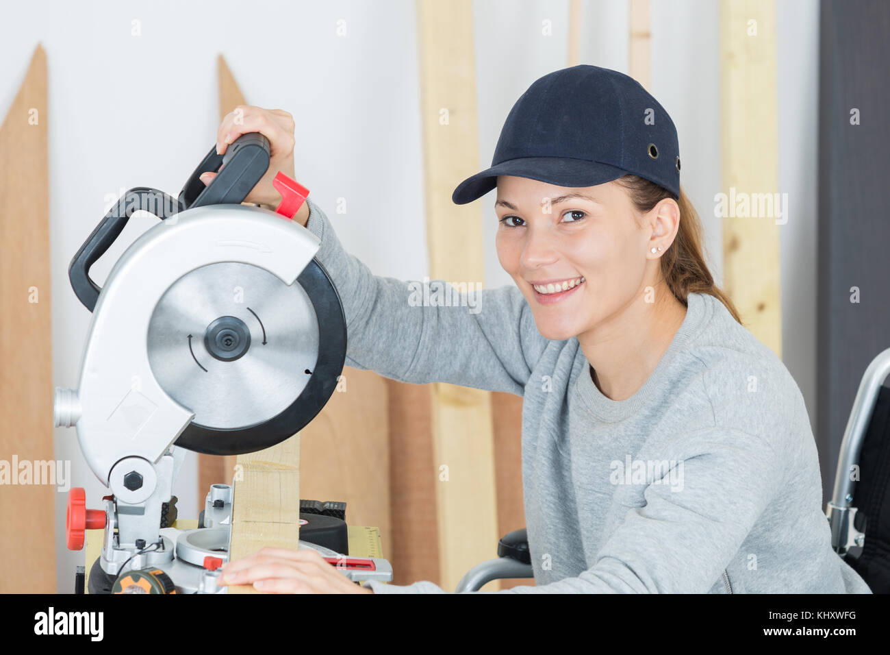 Portrait of disabled woman using circular saw Stock Photo - Alamy