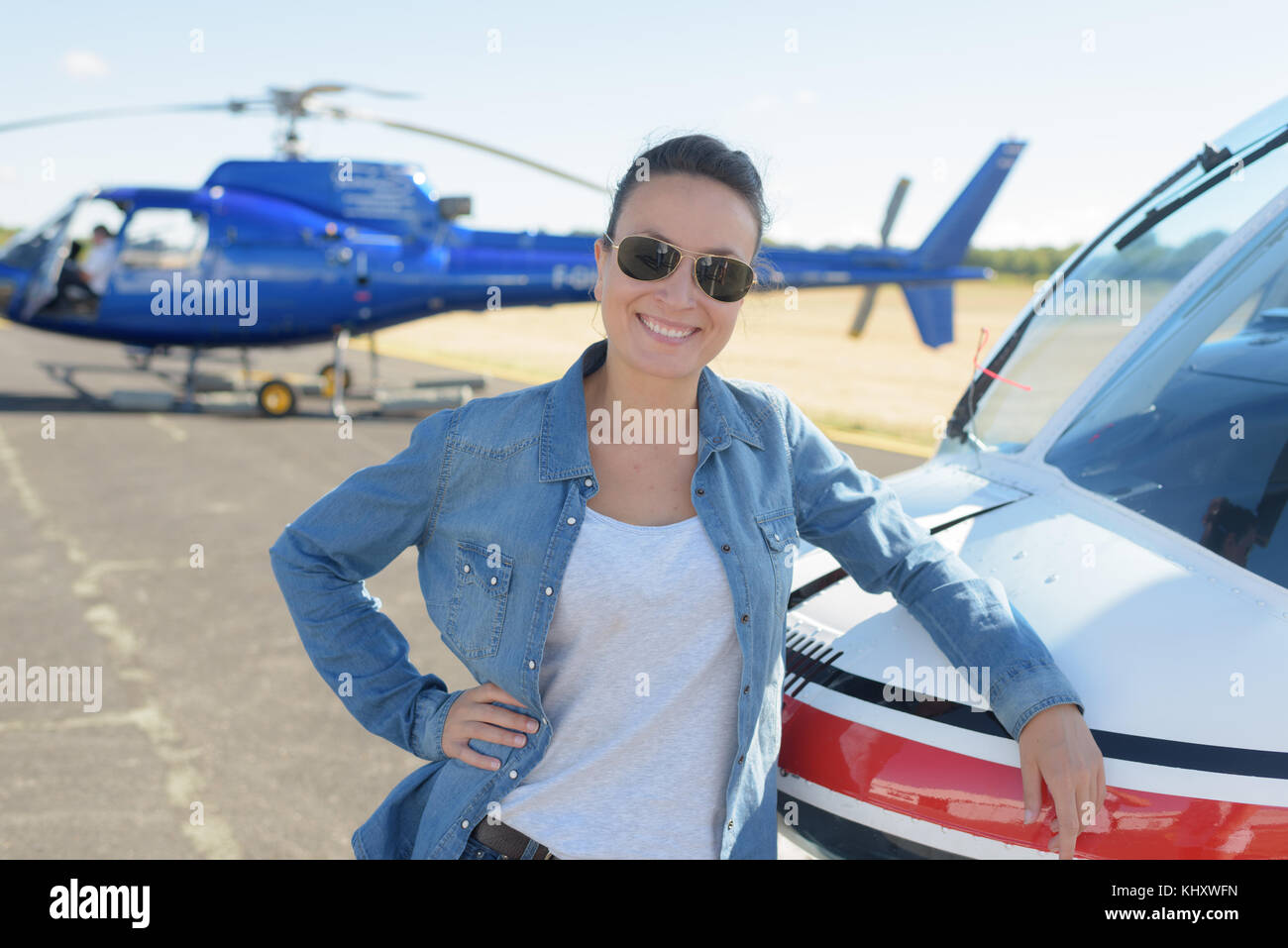 pretty pilot woman on helicopter background Stock Photo - Alamy