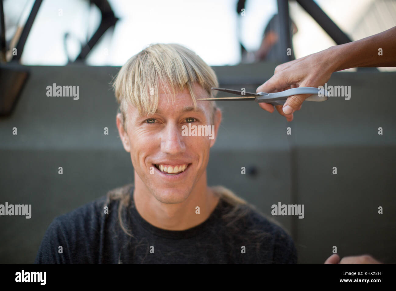 Portrait of young man having haircut Stock Photo - Alamy