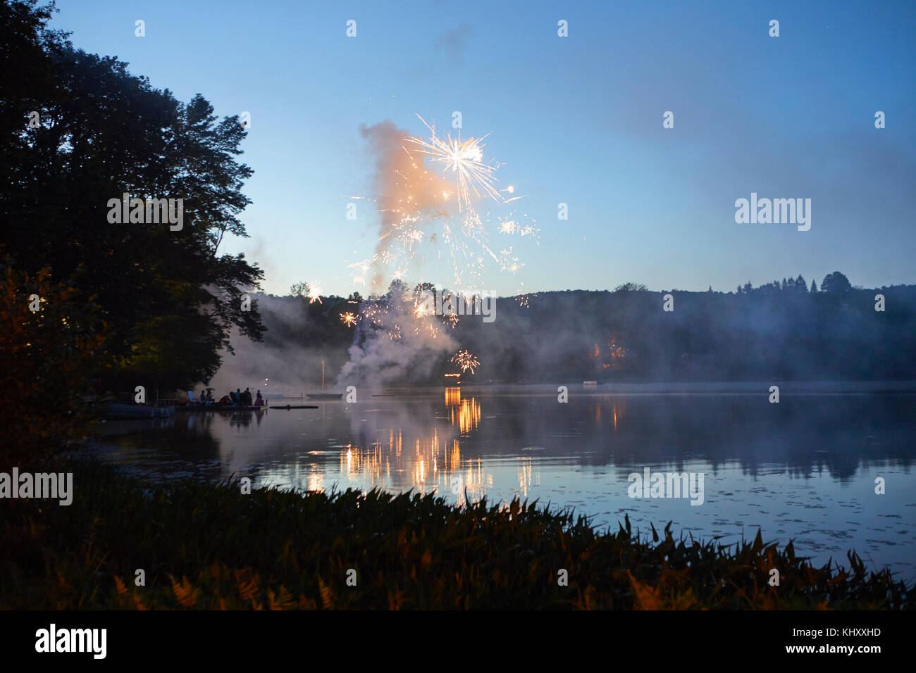 Fireworks exploding over lake Stock Photo - Alamy