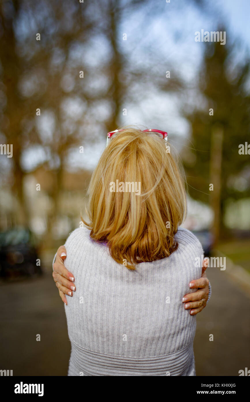 Woman hugging herself hi-res stock photography and images - Alamy
