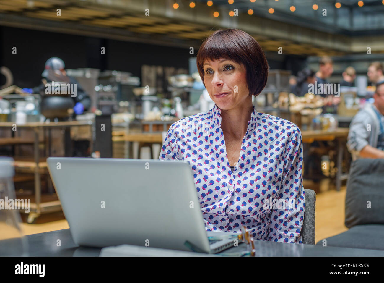 Woman in office using laptop Stock Photo - Alamy